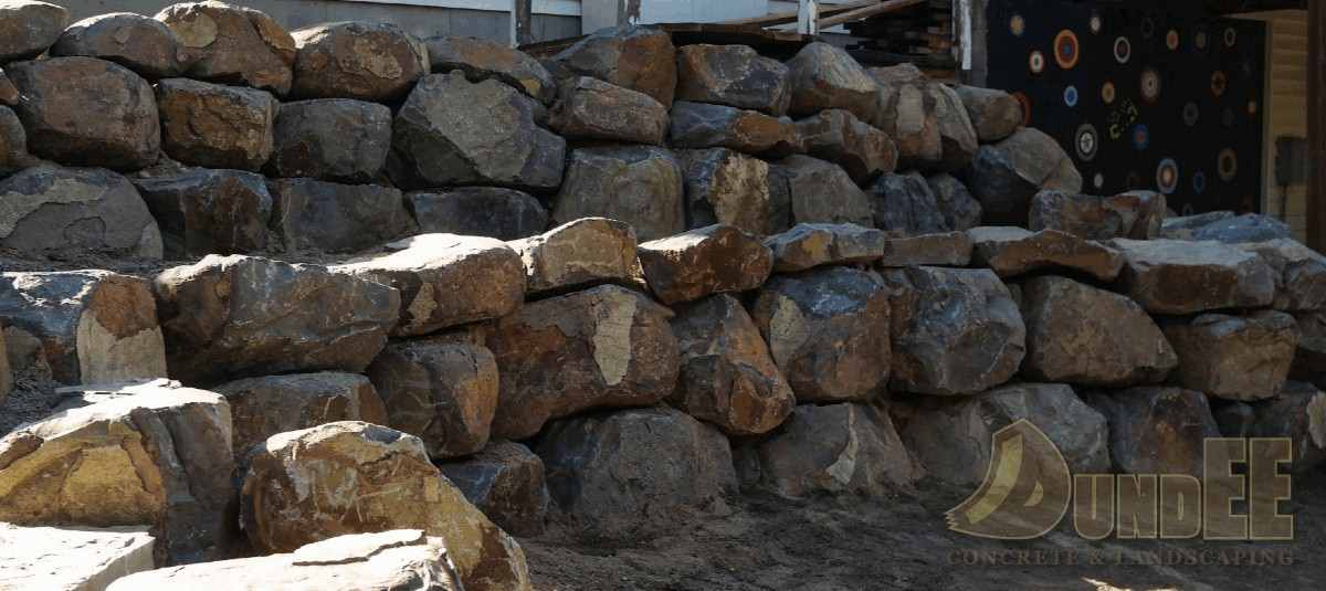 Boulder Retaining Wall Installations by Dundee LLC
